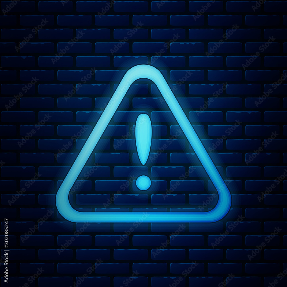 Glowing neon Exclamation mark in triangle icon isolated on brick wall ...