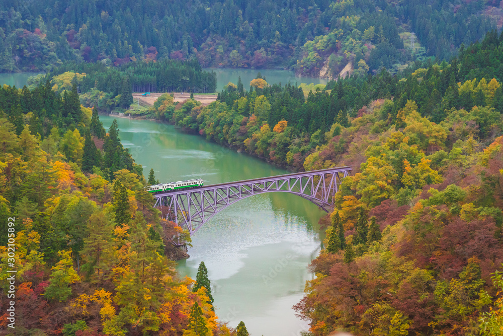Train crossing the first bridge at Tadami line with surrounding ...