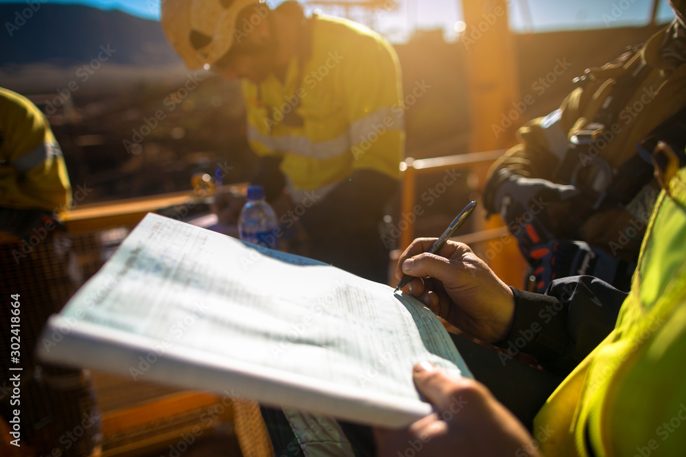 Construction miner workers signing working at height permit on open ...