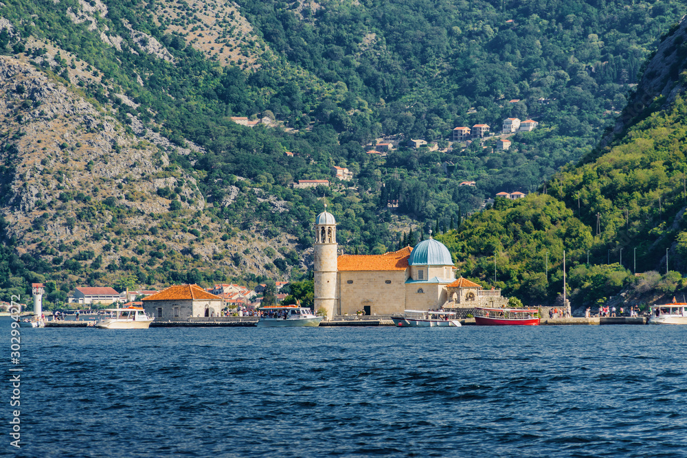 Sunny morning view of Gospa od Skrpjela, also known as Church Our Lady ...