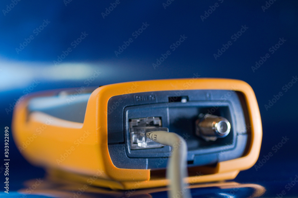 Ethernet UTP cable tester on blue background Stock Photo | Adobe Stock