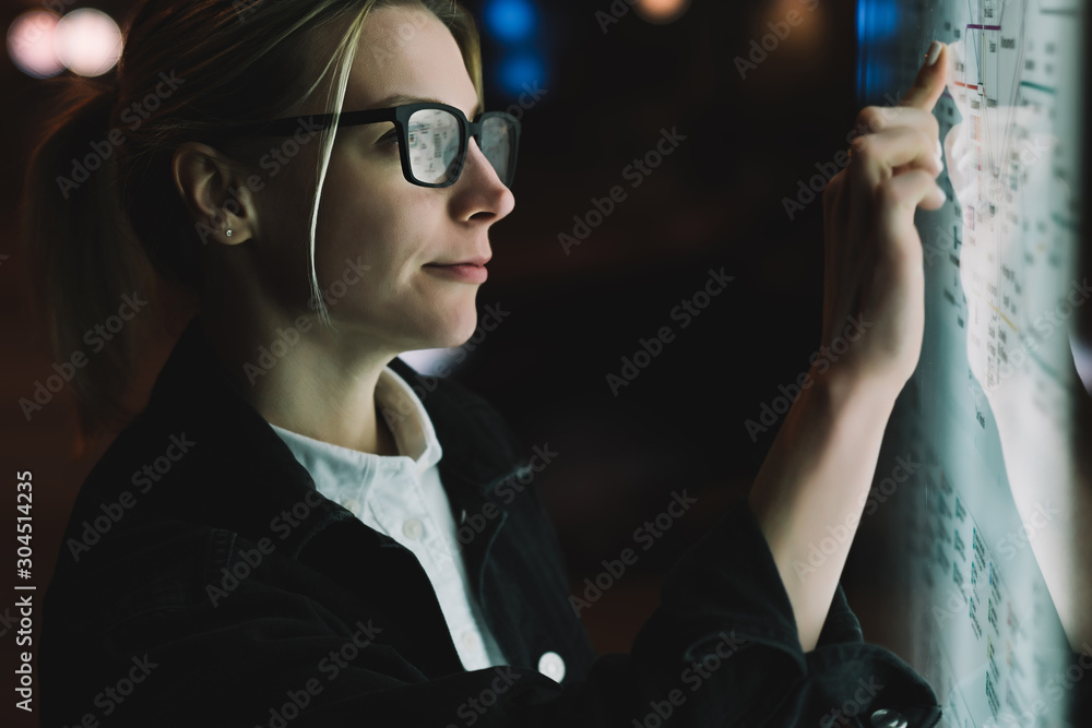 Interactive kiosk with public transport subway map. Female standing at ...