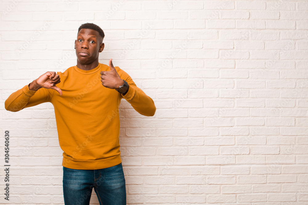 young african american black man feeling confused, clueless and unsure ...