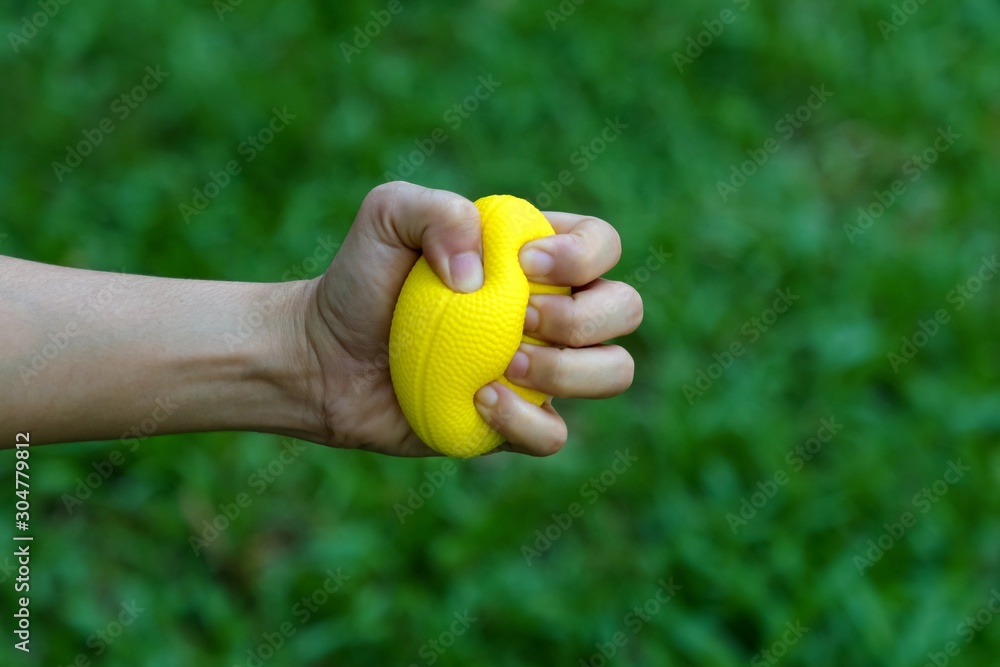 Hand holding stress ball and squeezing for relieve stress and ...