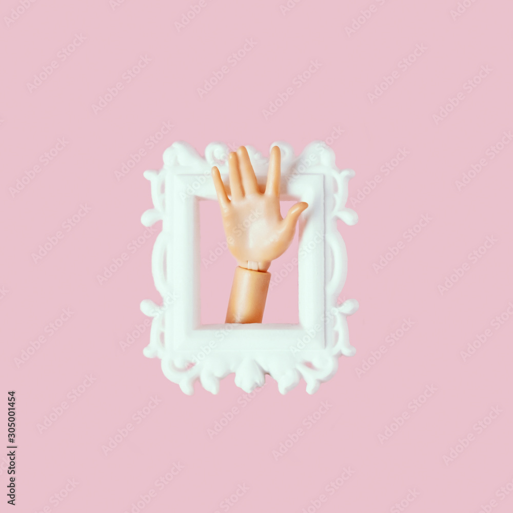 Doll hand in picture frame illustration. Plastic toy arm in ornate ...