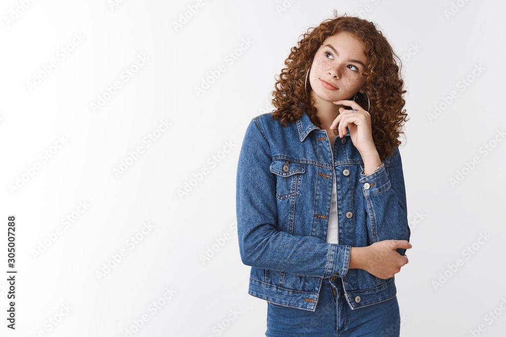 Dreamy thoughtful cute ginger girl curly-haired wearing denim lean head ...