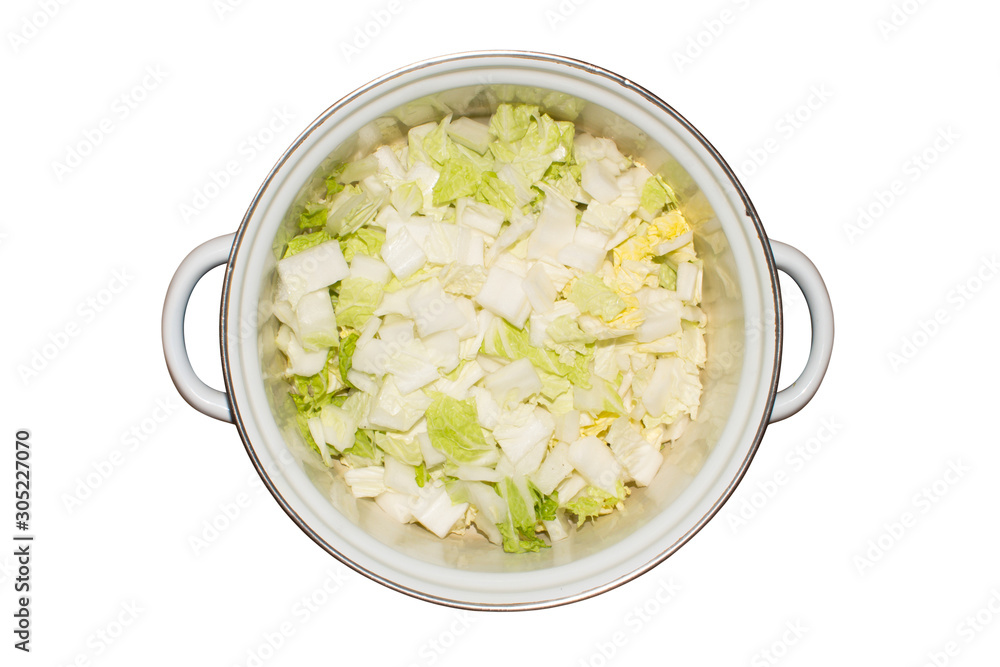 Peking cabbage, finely chopped.Peking cabbage in a saucepan on a white ...
