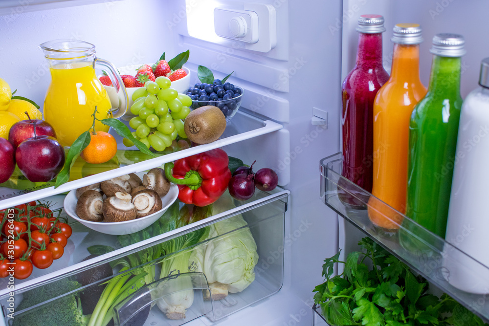 Food photography of a clean fridge filled with vegan foods such as ...