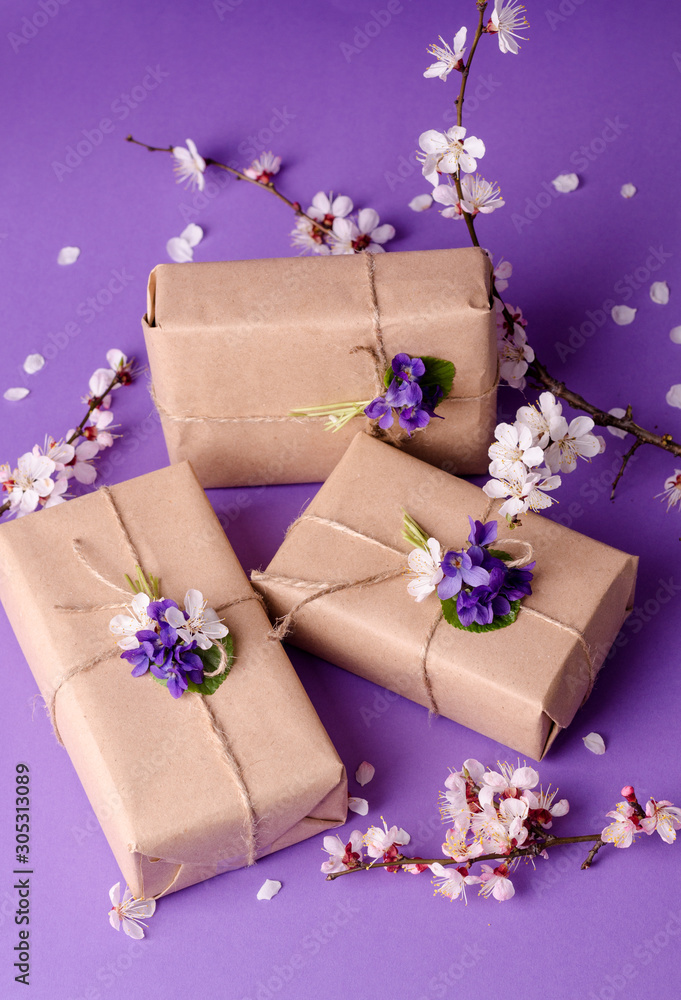 Beautiful gift boxes wrapped in simple brown craft paper decorated with ...