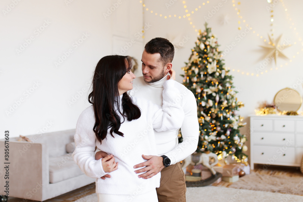 An attractive brunette girl in a white wool dress and a brutal man in a ...