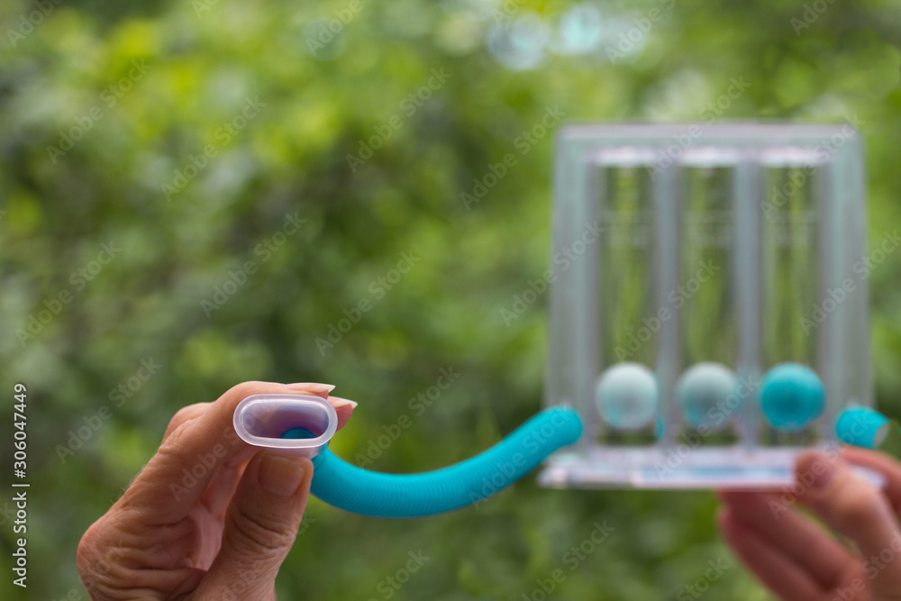 Hand holding Generic Spirometer breathing incentive exercise device ...