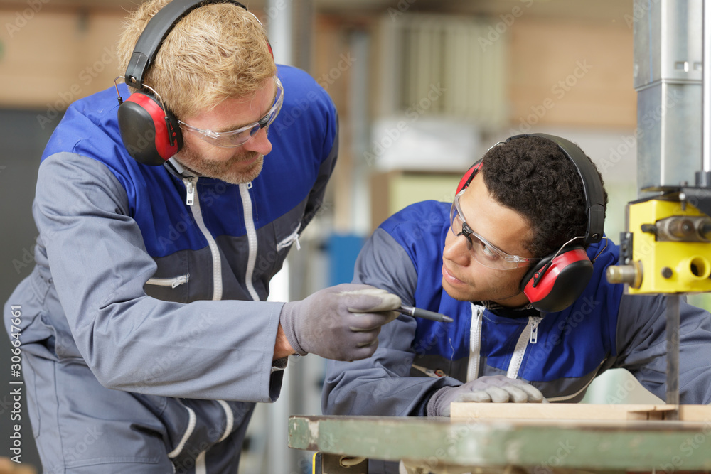young manual worker wearing protective clothing in metal industry Stock ...