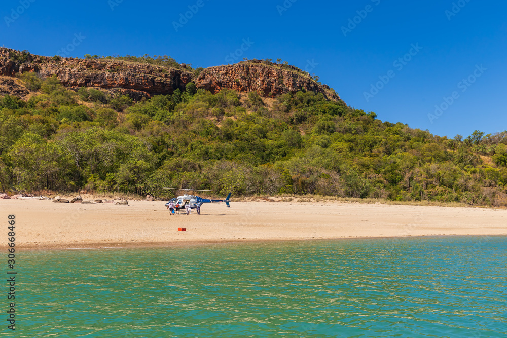 Tourists from a luxury expedition cruise ship board helicopters on a ...
