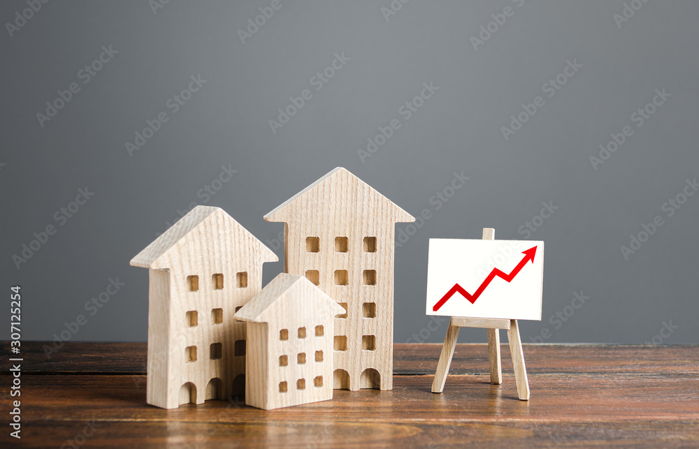 Residential buildings and easel with a positive growth trend red arrow up chart. Market growth ...