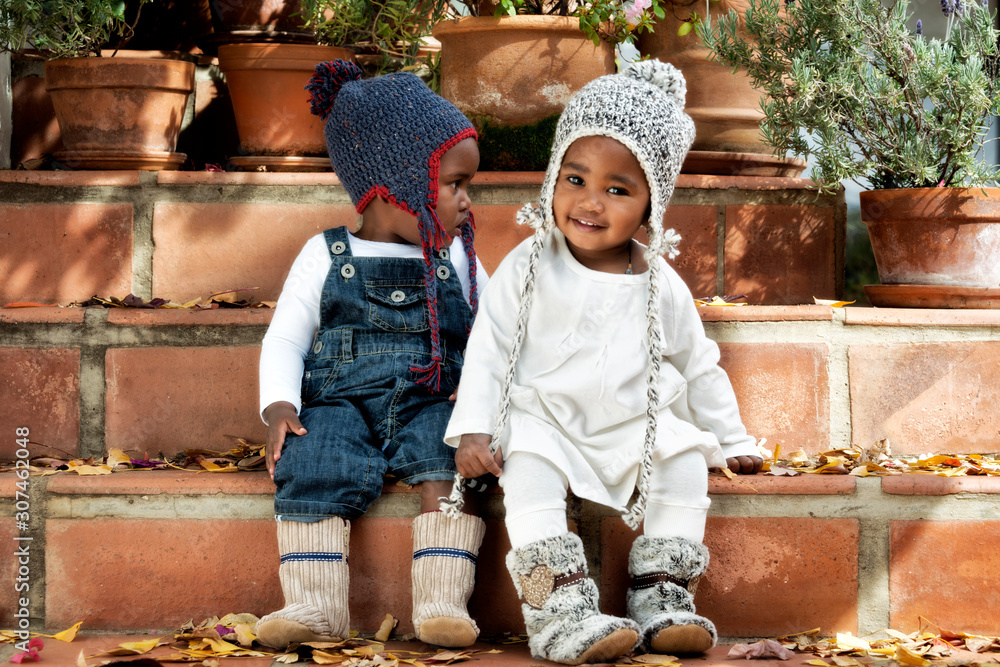 Little boy and girl sitting next to each other Stock Photo | Adobe Stock