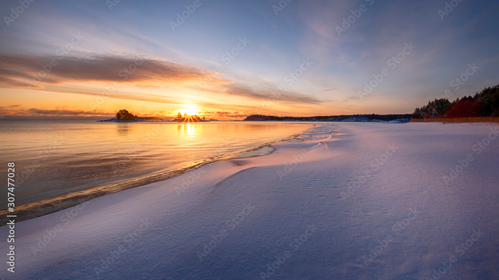 wide beach and winter sunrise on the lake Ladoga island Kajosaari ...