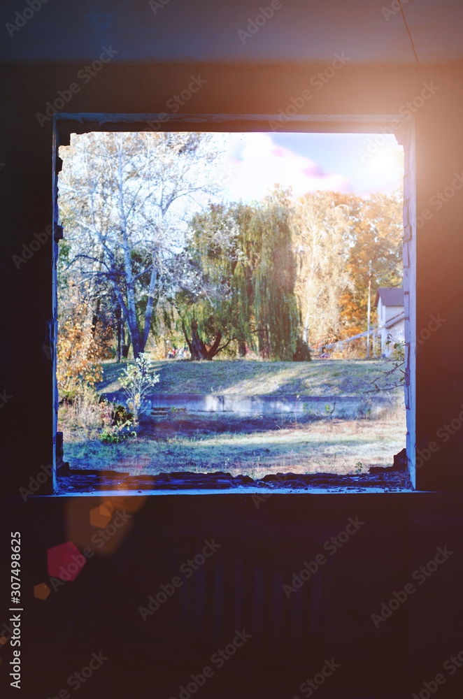 View from the window of crashed abandoned building, on autumn landscape ...