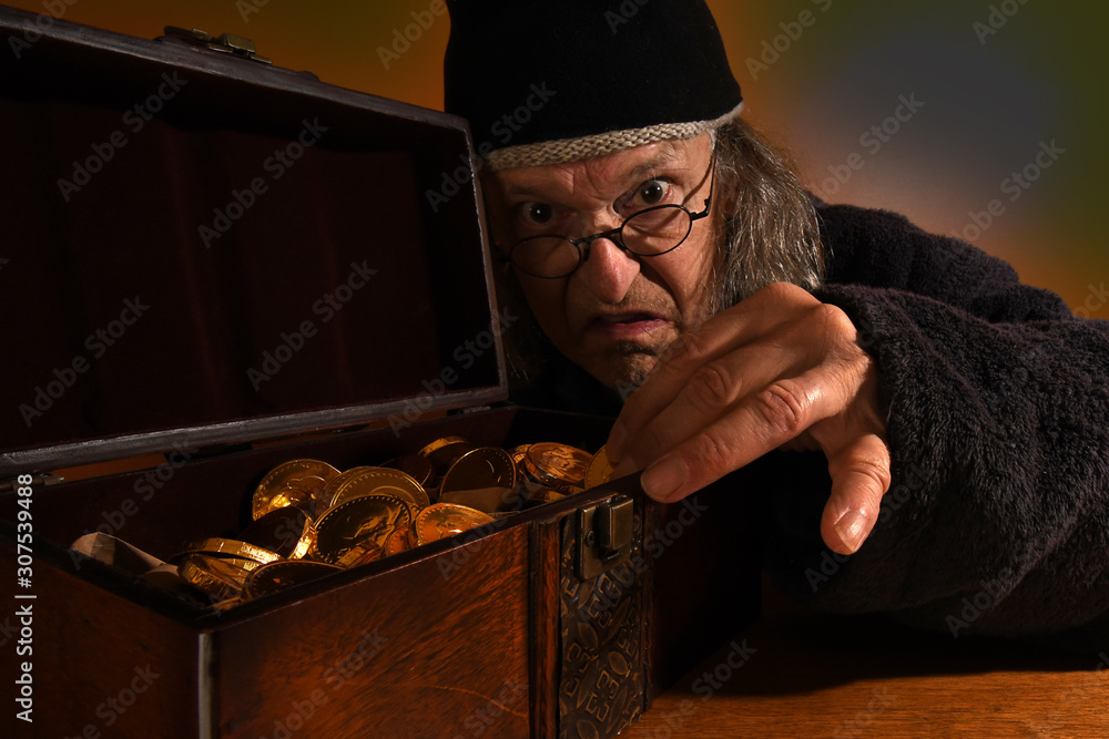 Old Scrooge making sure his gold coins are safe Stock Photo | Adobe Stock