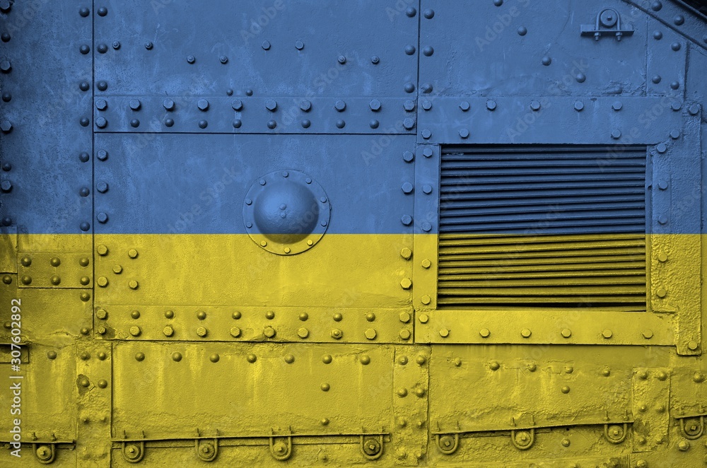 Ukraine flag depicted on side part of military armored tank closeup ...