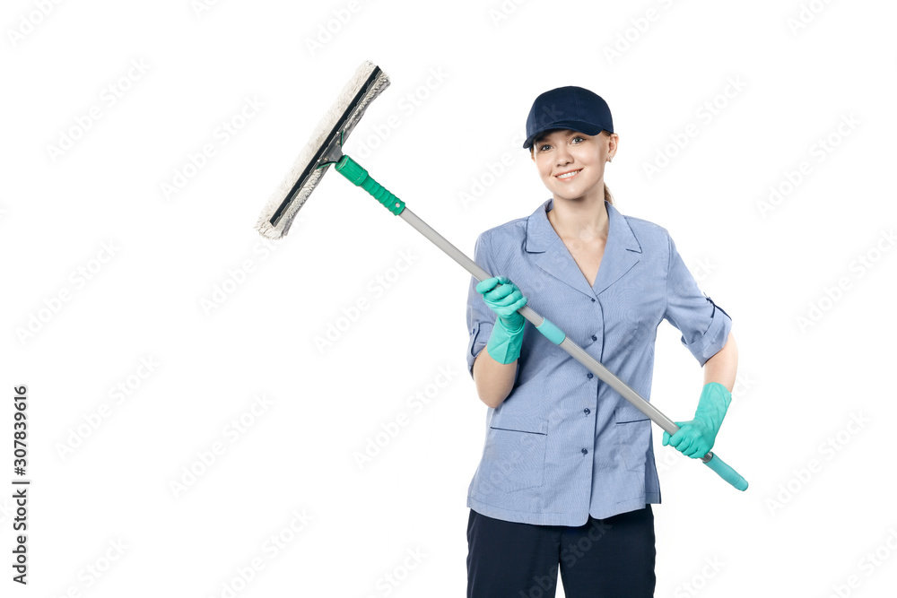 Brunette girl in a baseball cap and cleaning lady uniform washing a ...