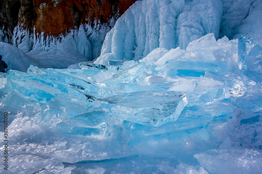 Transparent pieces of ice near the cliff on Lake Baikal. Beautiful blue ...