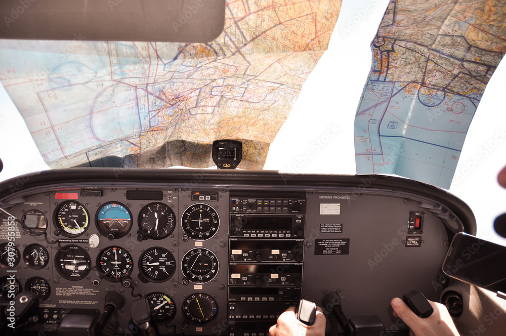Pilots in flight deck with charts all over the cockpit trying to ...
