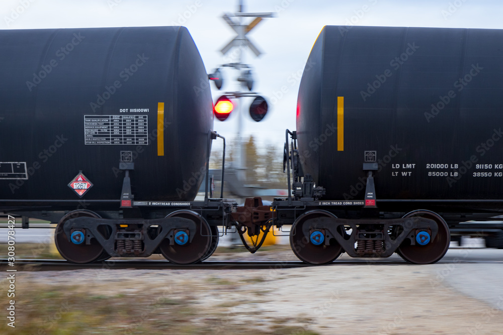 Tank Cars Connected Together Passing a Flashing Railway Crossing Stock ...