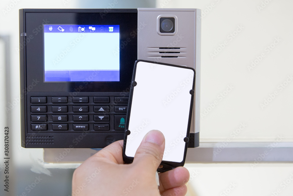 Close up hand using white keycard to open door access control by ...