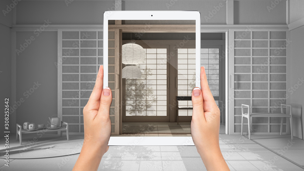 Hands holding tablet showing empty japanese space, tea room, total ...
