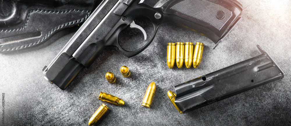 Detail of 9mm pistol, bullets and handcuffs. Gun with ammunition on ...
