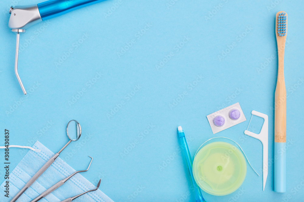 Dentist tools over light blue background top view copy space flat lay ...