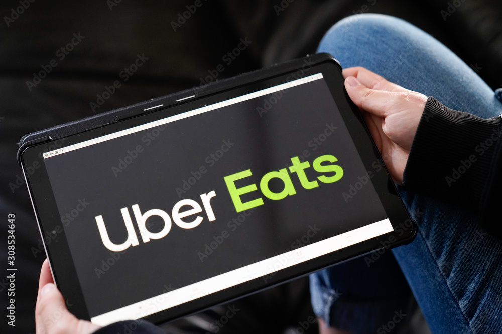 Foto de Stock Uber Eats sign logo tablet home application UberEats food ...