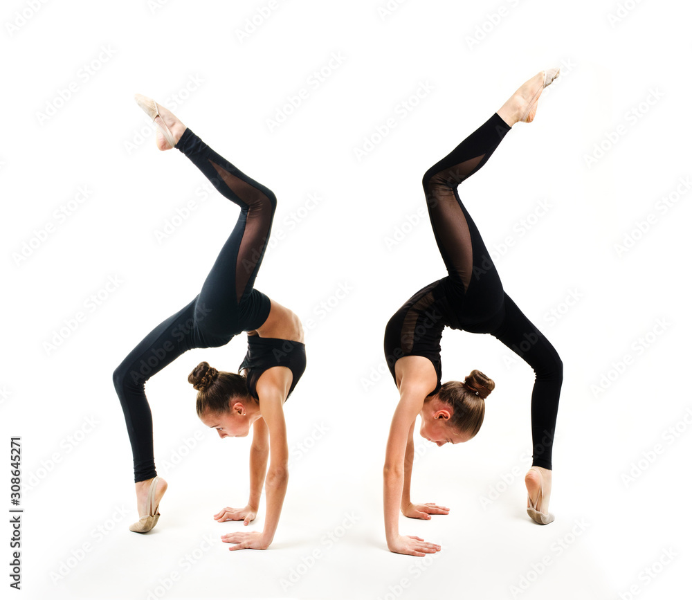 Two flexible cute little girls gymnast doing acrobatic exercise with ...
