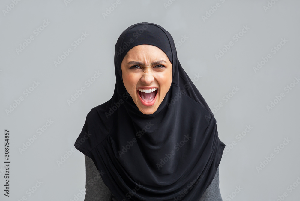 Angry muslim girl in hijab screaming loud, emotionally protesting about ...