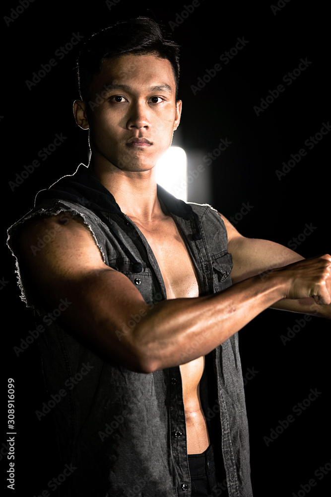 Muscle bodybuilder asia men posing muscle front on the black background ...