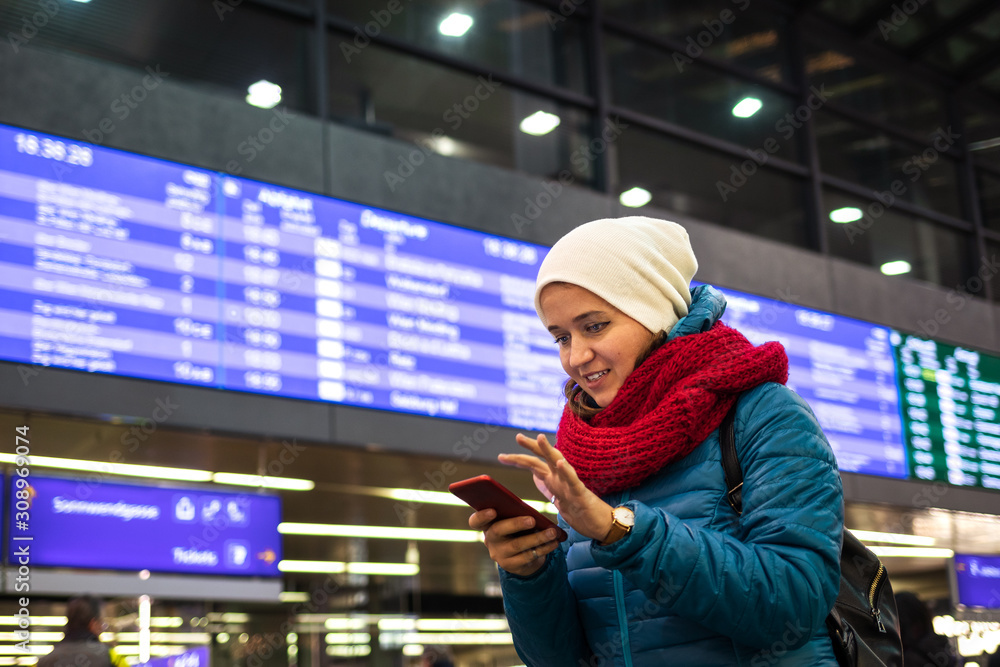 Young woman is booking railway ticket by using mobile app on her ...