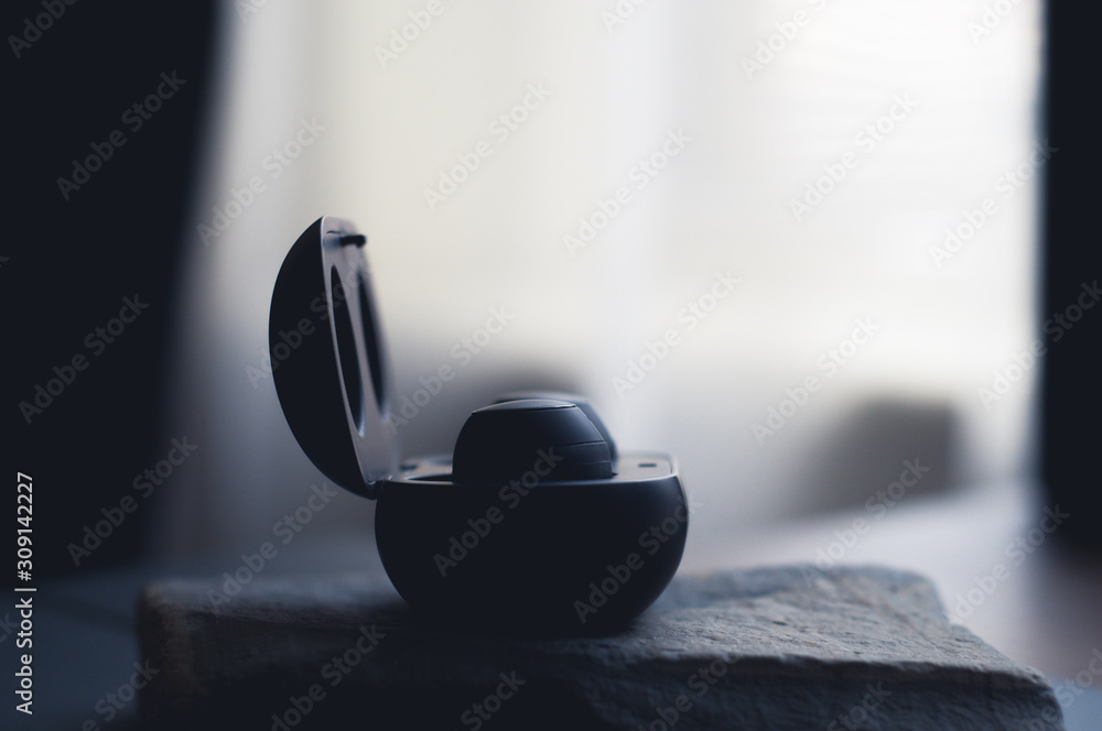 Black wireless earbuds Stock Photo | Adobe Stock