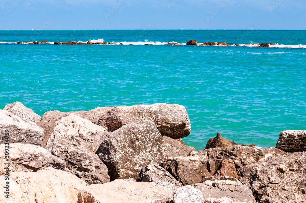 Massive stones rocks lying on the beach as a border between pebble ...
