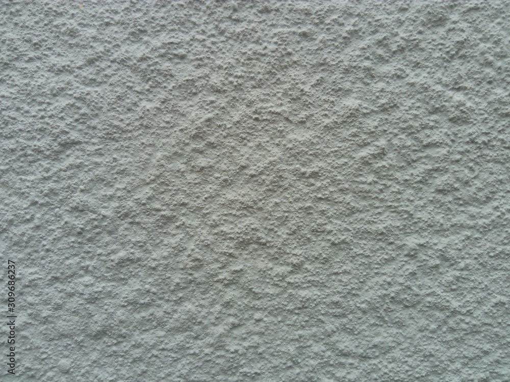 Plastered white wall. The finishing layer is formed by hardened mortar ...