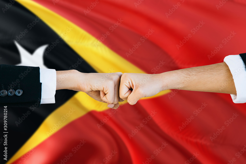 East Timor agreement concept. Man and woman fist bumping on national ...