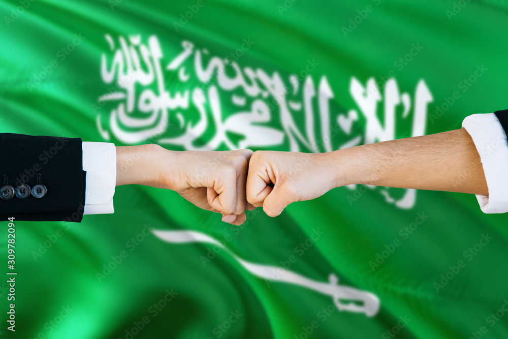 Saudi Arabia agreement concept. Man and woman fist bumping on national ...
