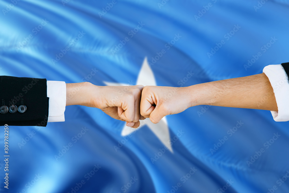 ภาพถ่าย Stock Somalia agreement concept. Man and woman fist bumping on ...