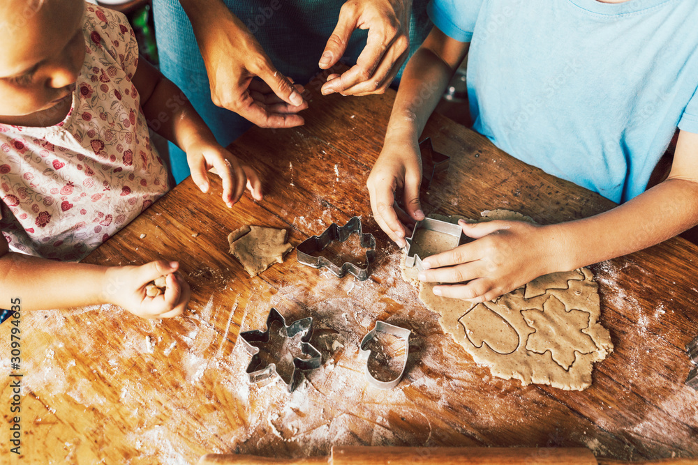 Joint family cooking of festive Christmas gingerbread in the kitchen ...