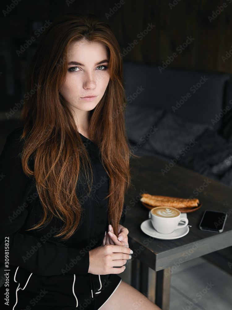 Cute Redhead Woman Woman With Serious Facial Expression Sitting In Cozy City Cafe Enjoying Free