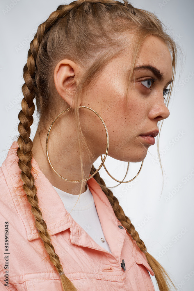 Close-up shot of a blonde European girl with big hoop earrings made of ...