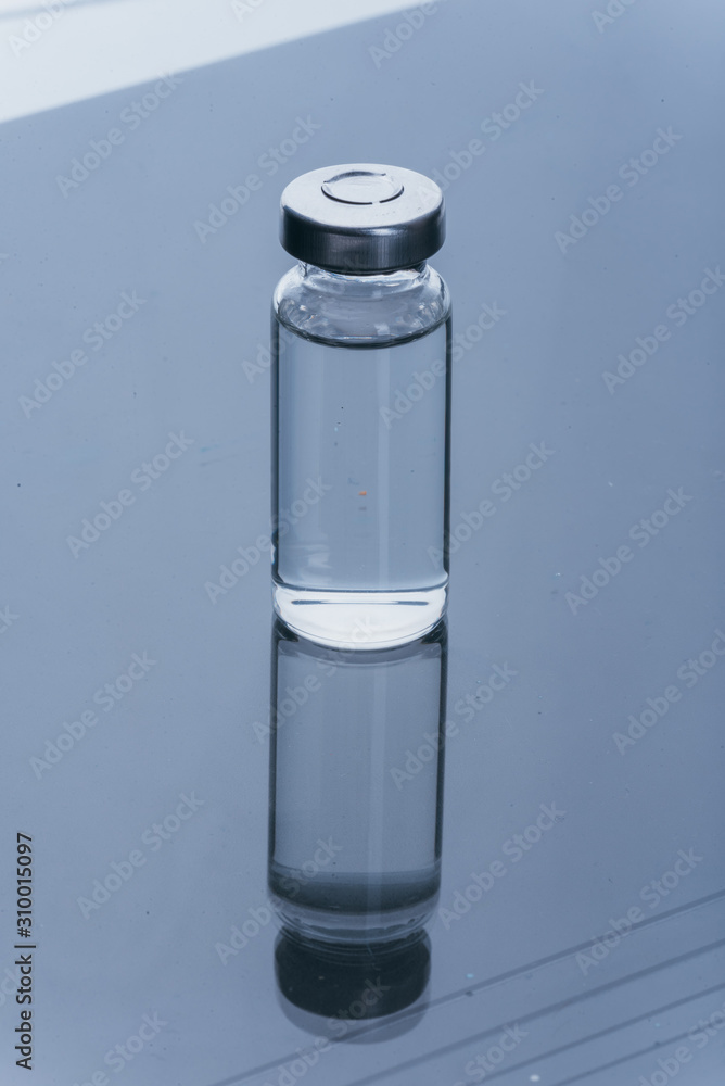 Glass medical ampoule vial for injection. Medicine is dry white drug ...