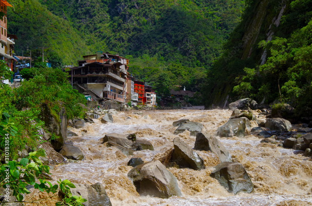 Roaring and powerful rapids of Urubamba River in valley between ...