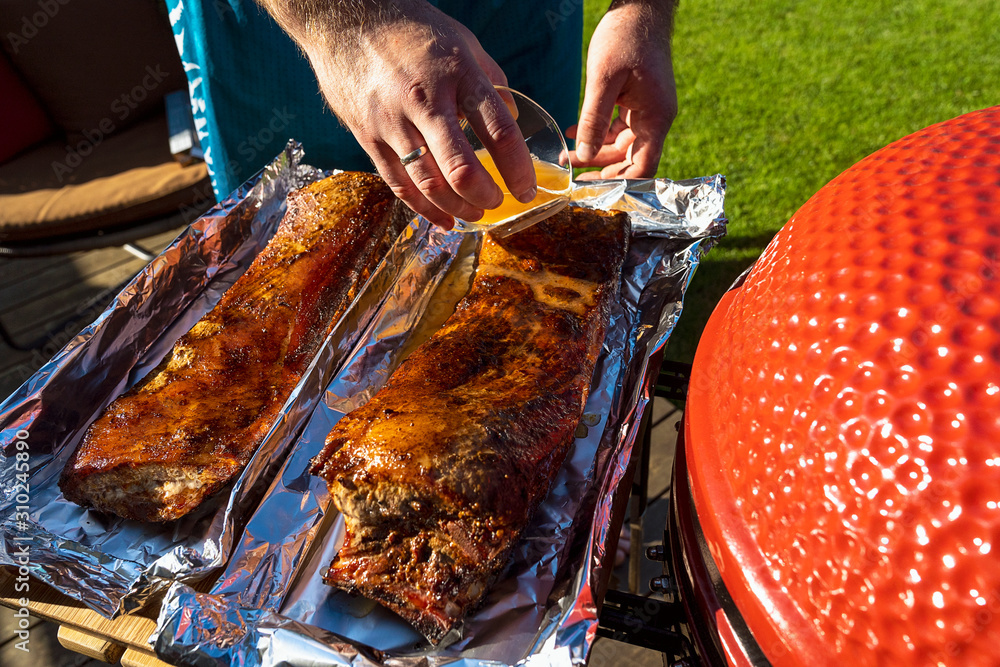 Preparation process of barbecue ribs on grill. Two racks of grilled ...