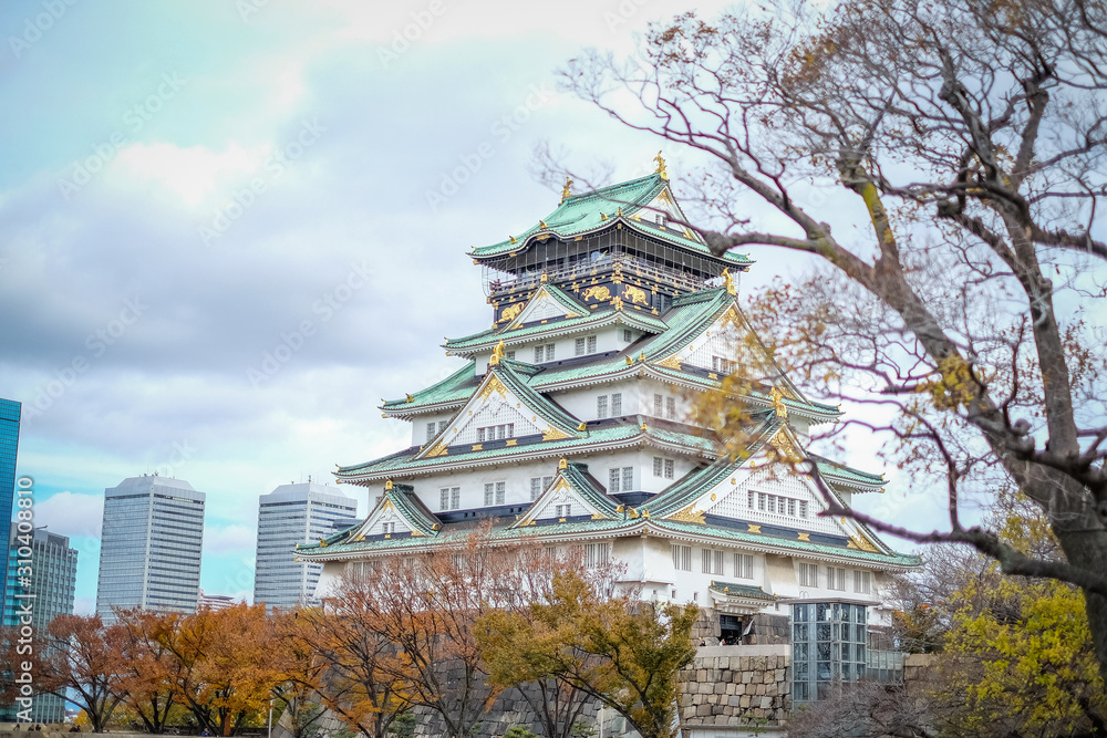 Osaka castle with modern building and blue sky background in autumn ...