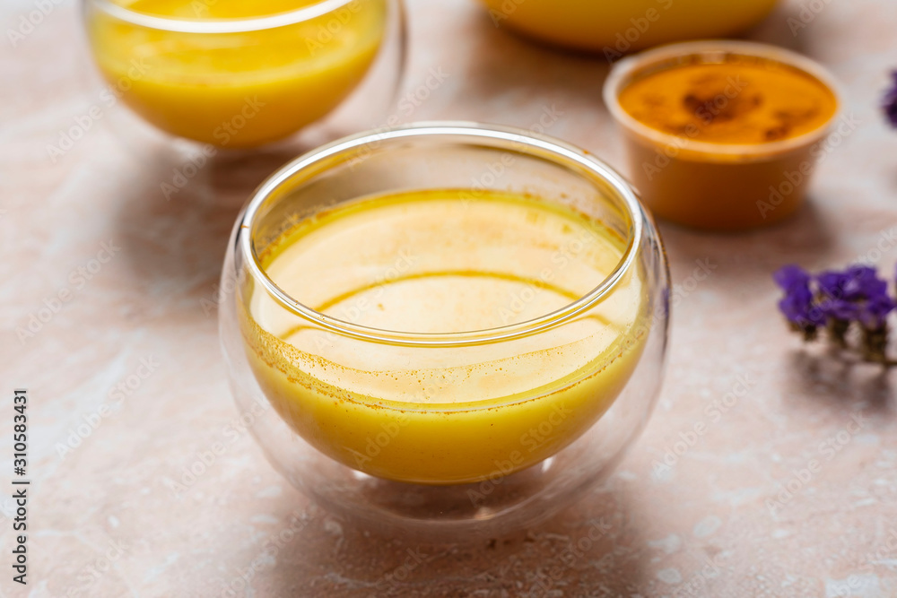 Masala Haldi Doodh. Healthy golden milk with turmeric and honey on a ...